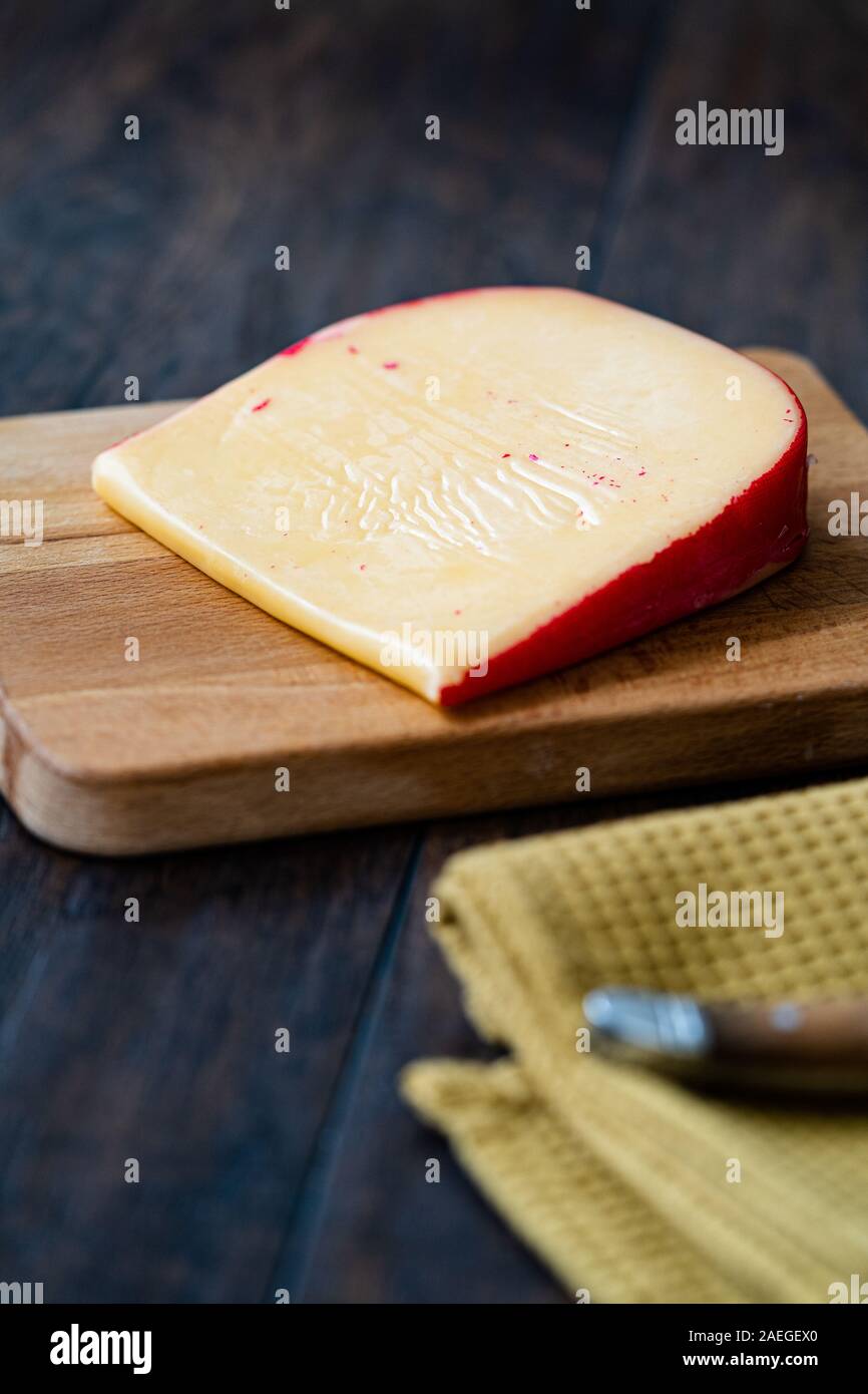 Hard Dutch Gouda Cheese, Close-up on Wooden Board with Knife. Organic ...