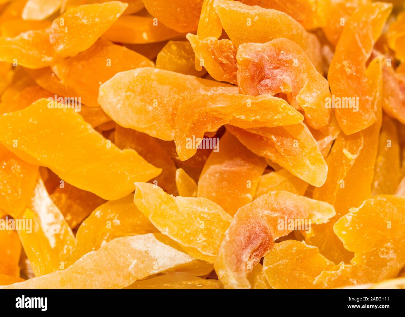 candied mango slices as a background Stock Photo - Alamy