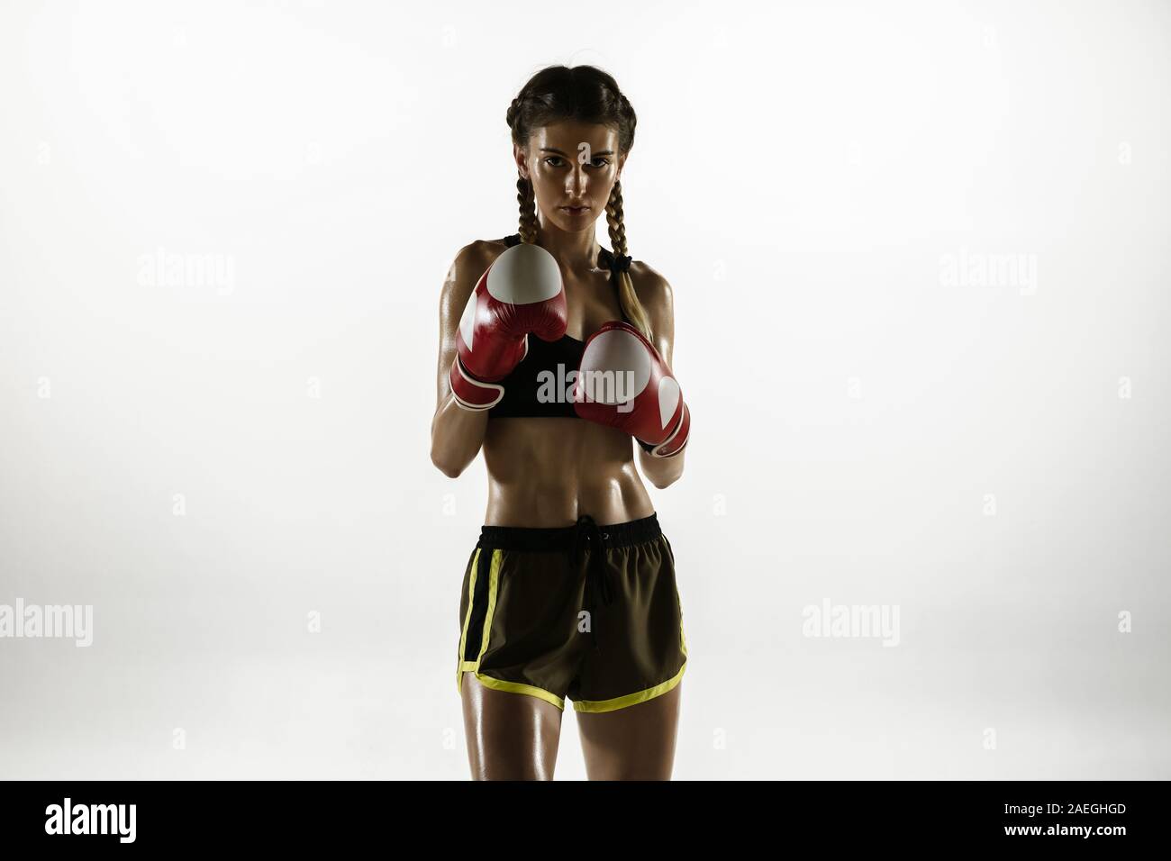 Fit caucasian woman in sportswear boxing isolated on white studio ...