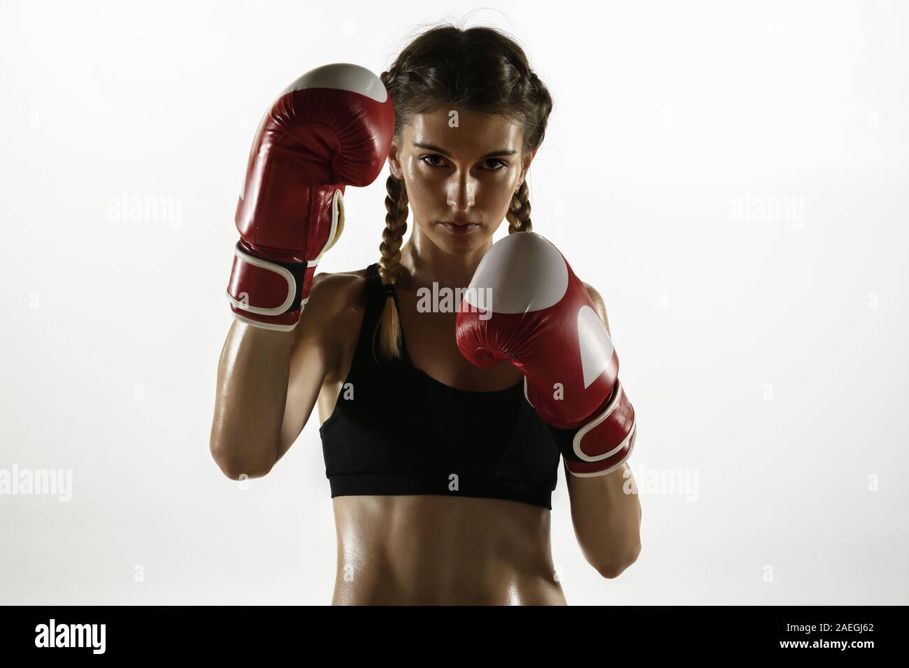 Fit caucasian woman in sportswear boxing isolated on white studio ...