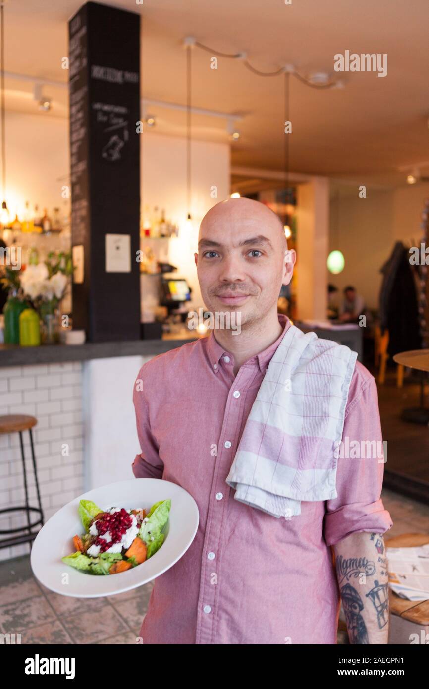 waiter holding a plate at Bar Spek, Amsterdam the Netherlands Stock ...