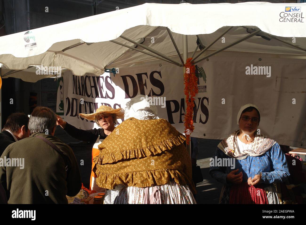Tasting of Provencal specialities in the street in traditional costume ...