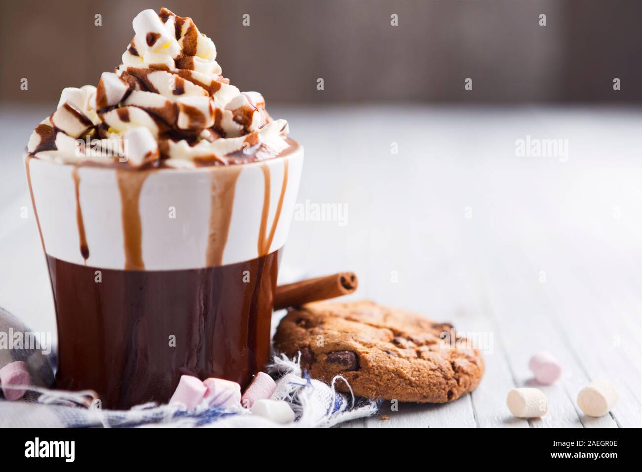 A messy cup with hot chocolate, whipped cream, marshmallows and ...