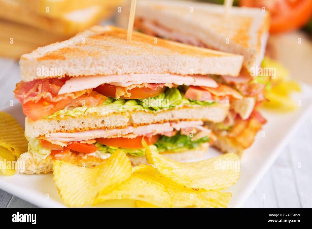 A club sandwich on a rustic table in bright light Stock Photo - Alamy