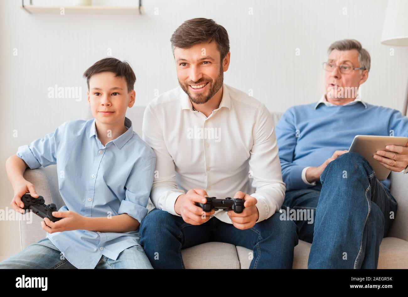 Man Playing Video Games With Son And Elderly Dad Indoor Stock Photo - Alamy