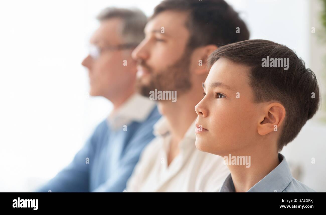 Portrait Of Boy, Father And Grandfather Sitting At Home, Side-View ...