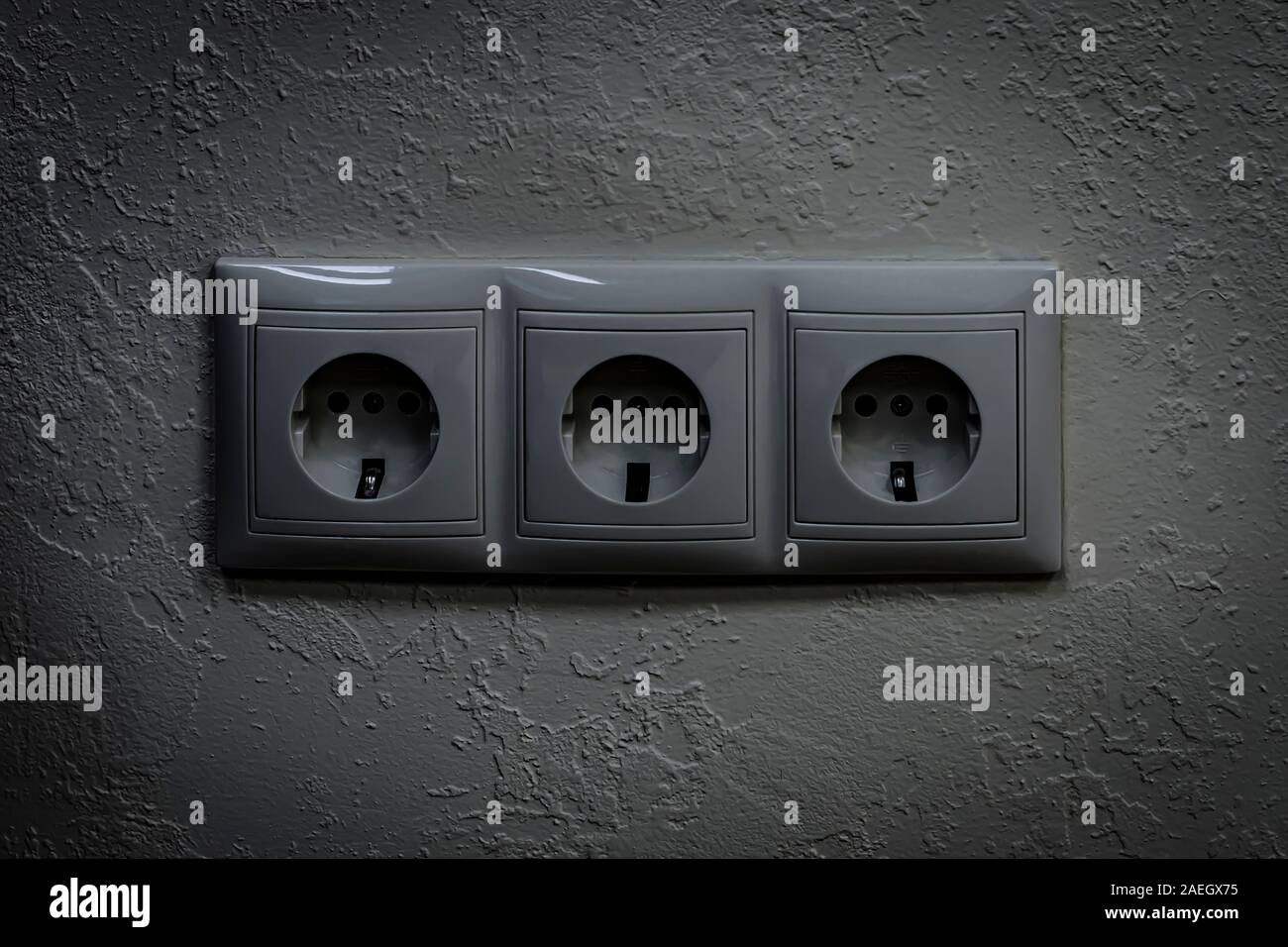 Triple electrical outlet. Black and white dramatic vignette shot. Front ...