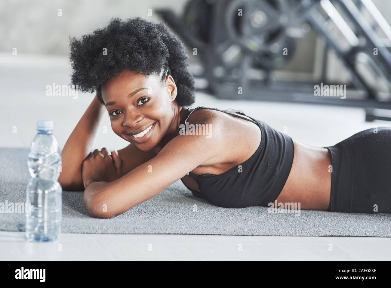 Getting ready for the exercises. African american woman with curly hair ...