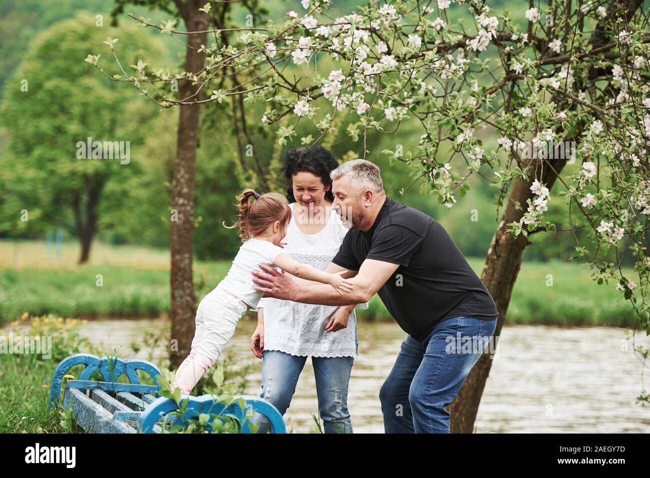 Come to me. Cheerful couple enjoying nice weekend outdoors with ...