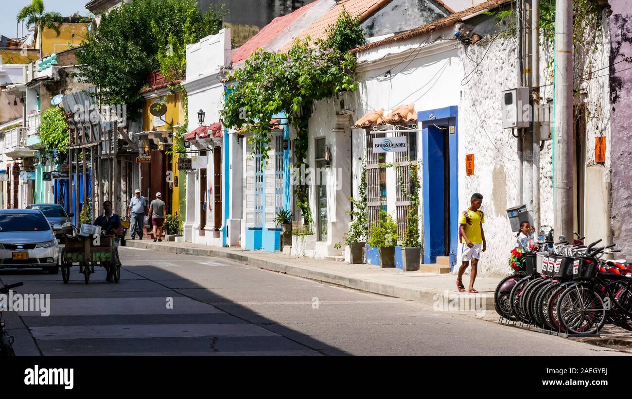 Streets of Cartagena, Colombia. Locals walking on a typical street with ...