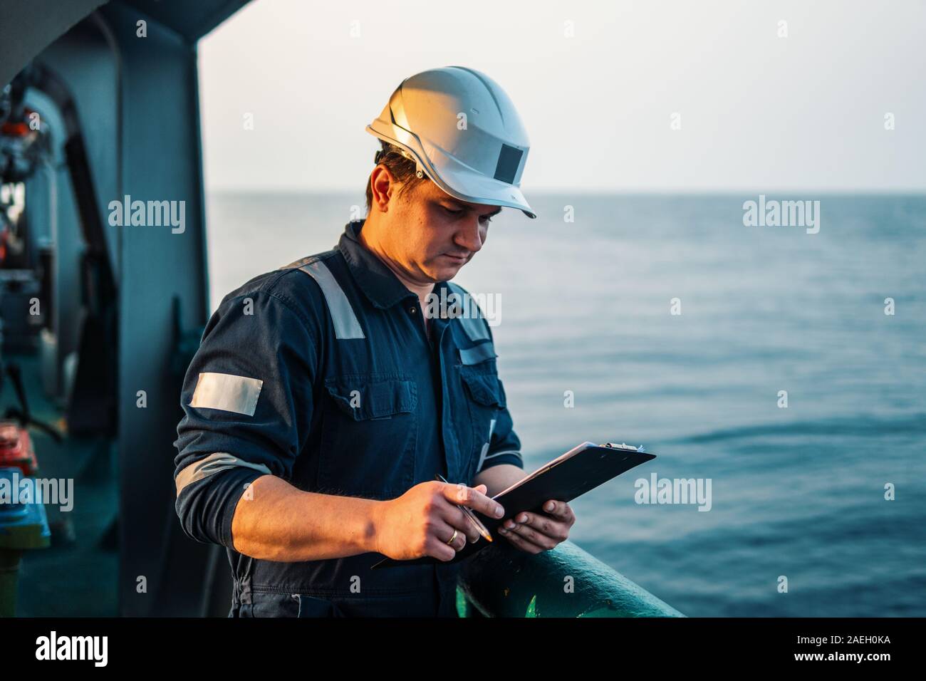 Deck Officer on deck of offshore vessel or ship , wearing PPE personal ...