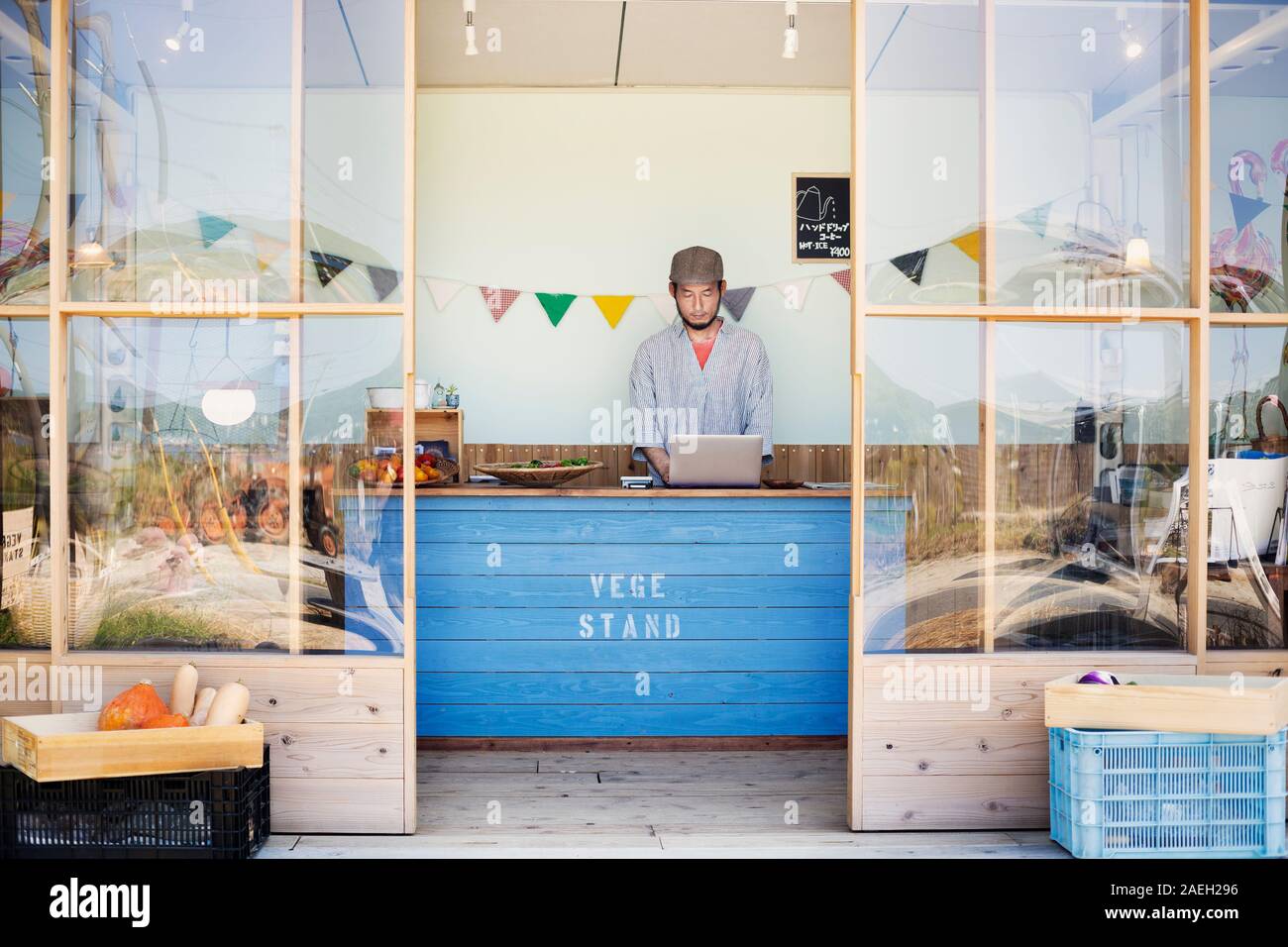 Japanese man wearing cap standing behind counter in farm shop Stock ...