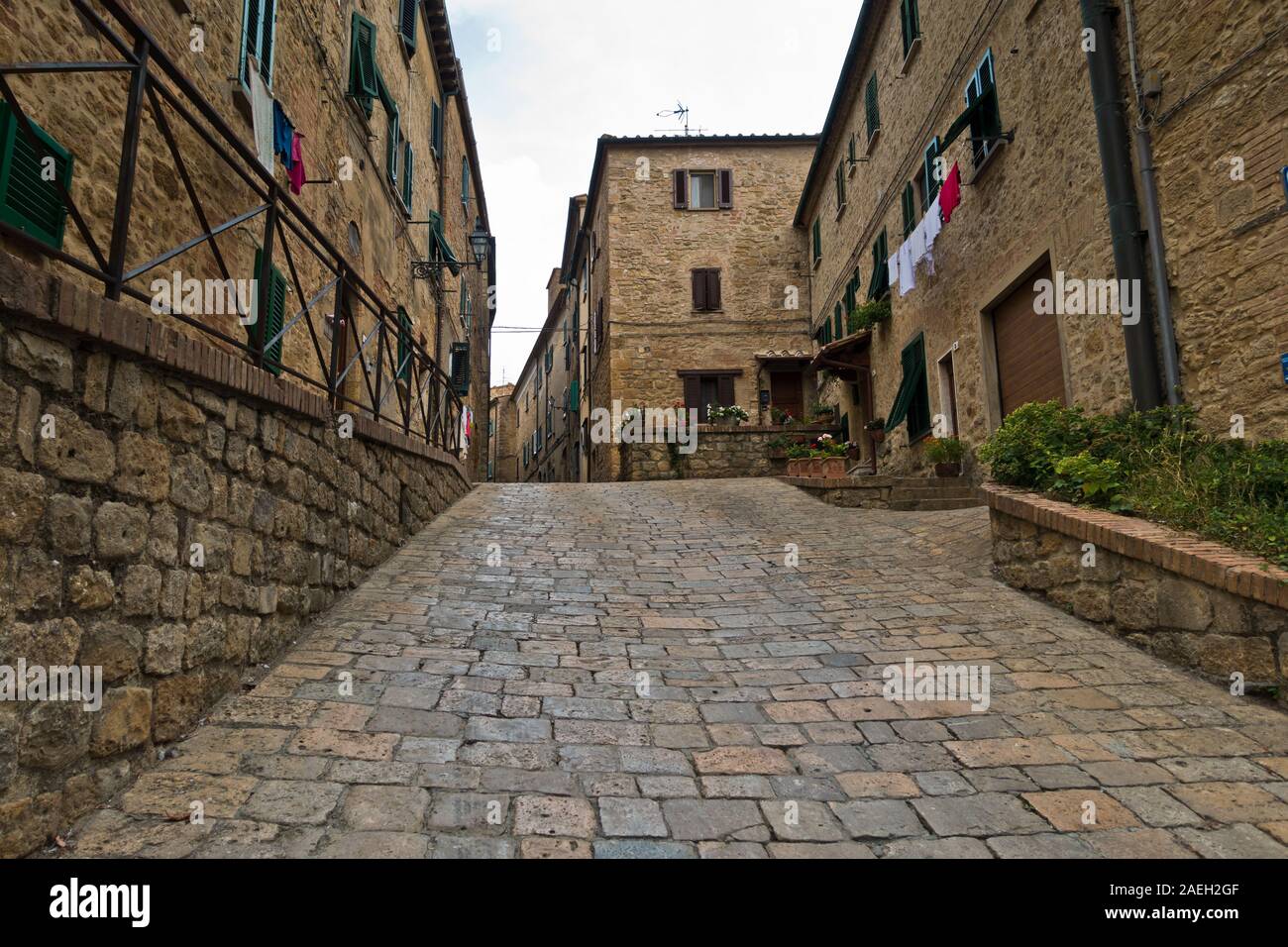 Steep cobblestone street surrounded by vintage stone buildings in ...