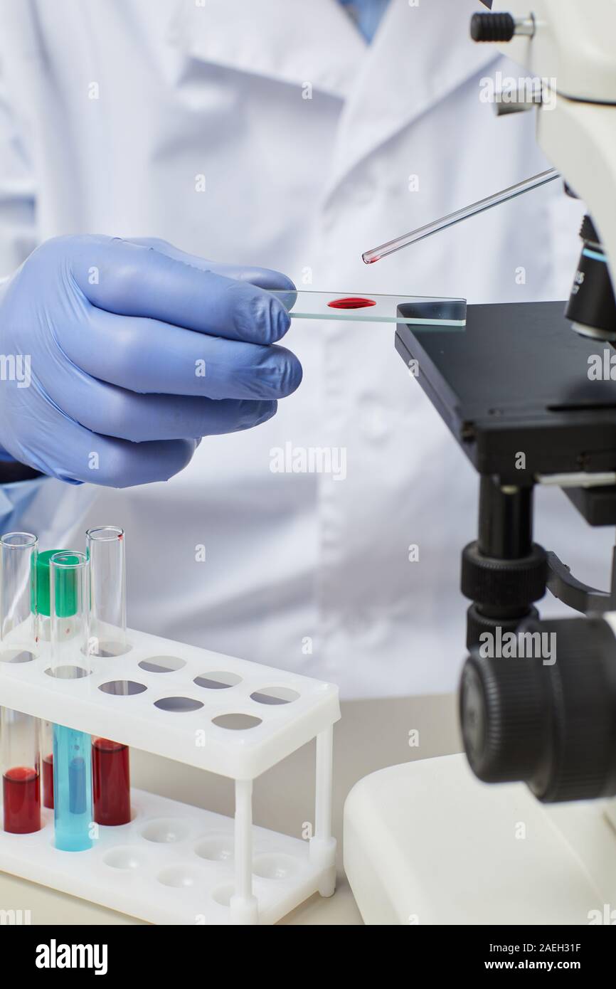 Chemist examining blood microscope close hi-res stock photography and ...