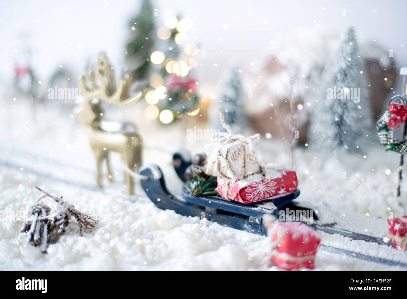 Miniature sled loaded of gifts a on snowy winter background Stock Photo ...