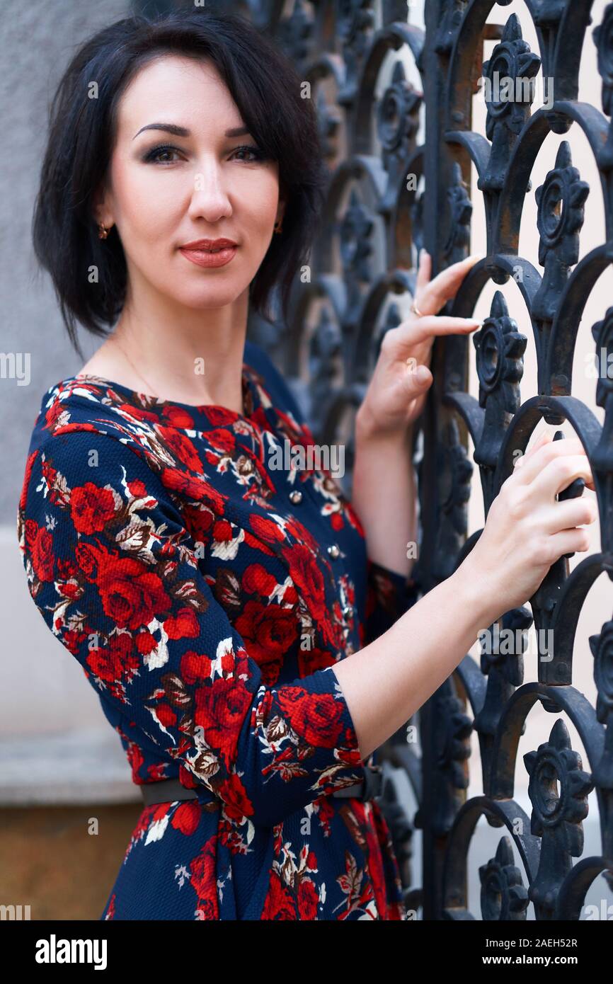 Beautiful elegant woman posing near black wrought iron gates Stock ...