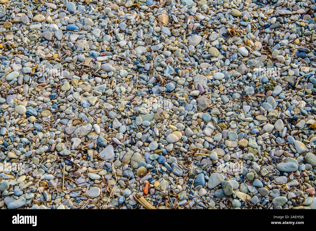 Small pebbles with twigs on a beach in Corfu as a background Stock ...
