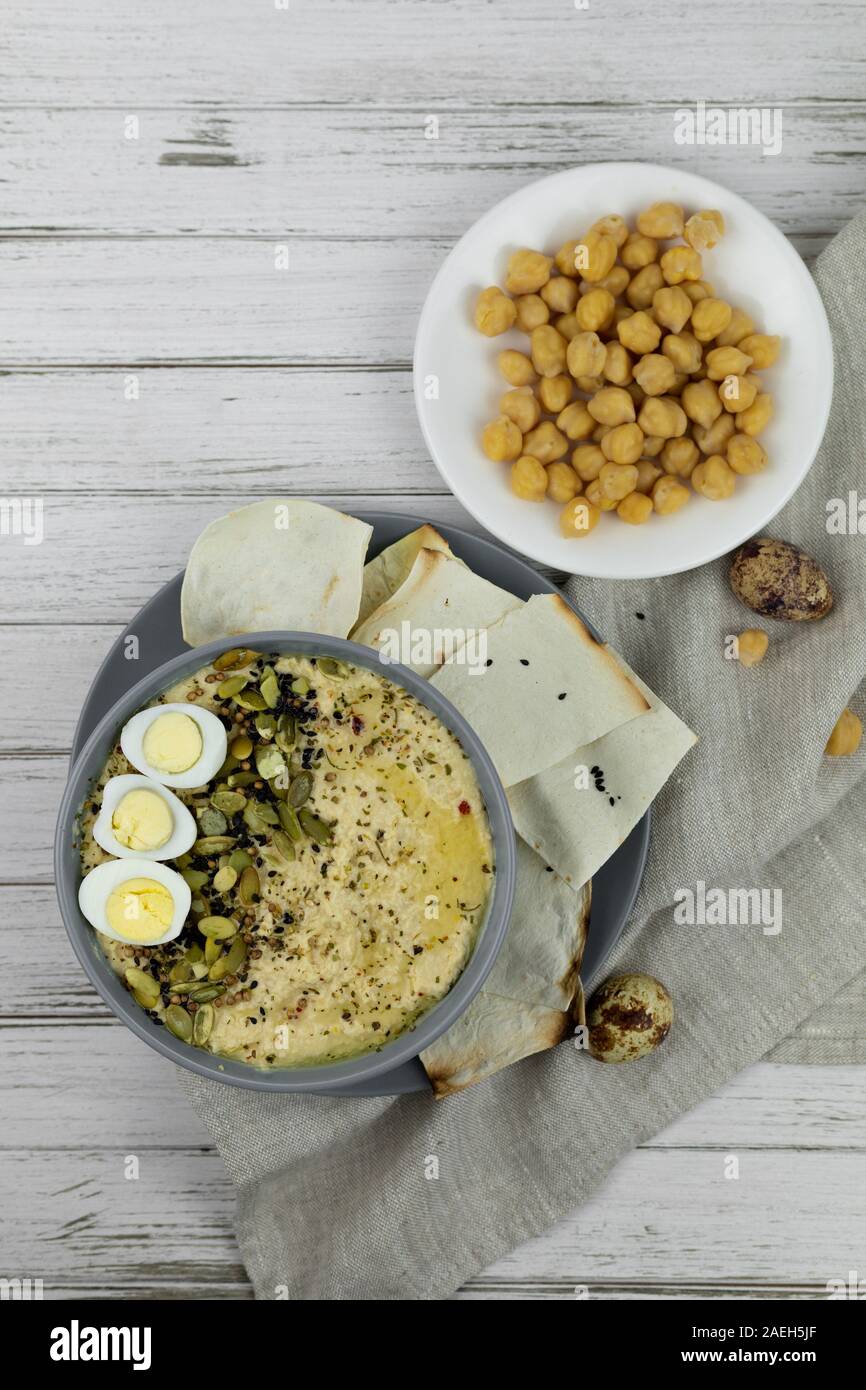 hummus is a traditional dish of eastern cuisine in a gray plate, on a ...