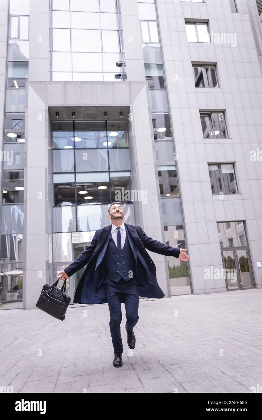 Happy brunette office worker running home with pleasure Stock Photo - Alamy