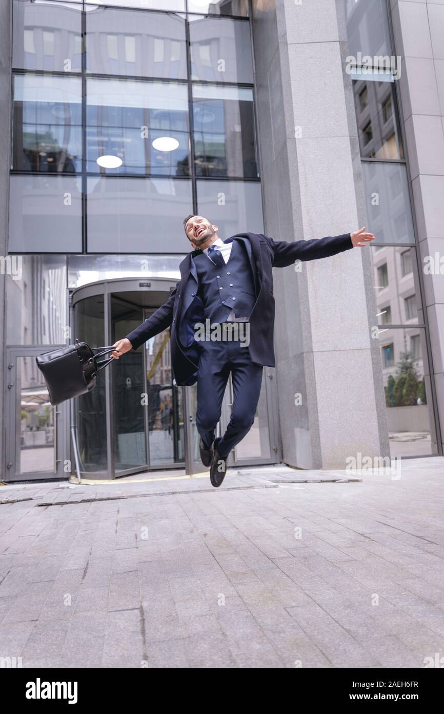 Joyful office worker jumping high after workday Stock Photo - Alamy