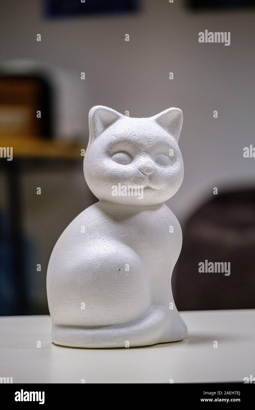 white toy cat on the table with blur background Stock Photo - Alamy