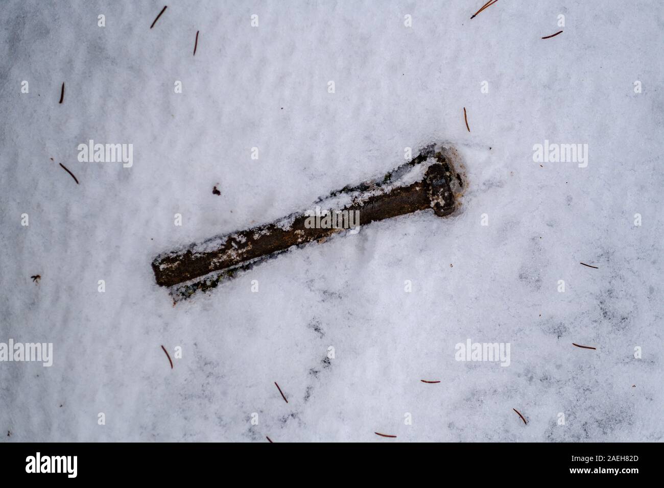 metal screw lost in white snow on the winter road Stock Photo - Alamy