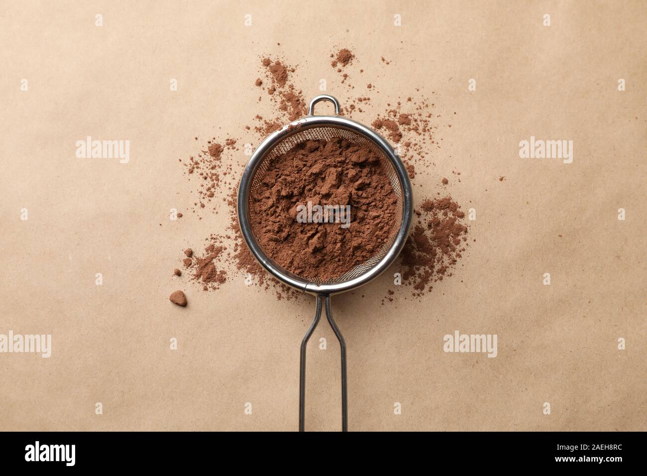 Strainer with cocoa powder on cardboard background, top view Stock ...