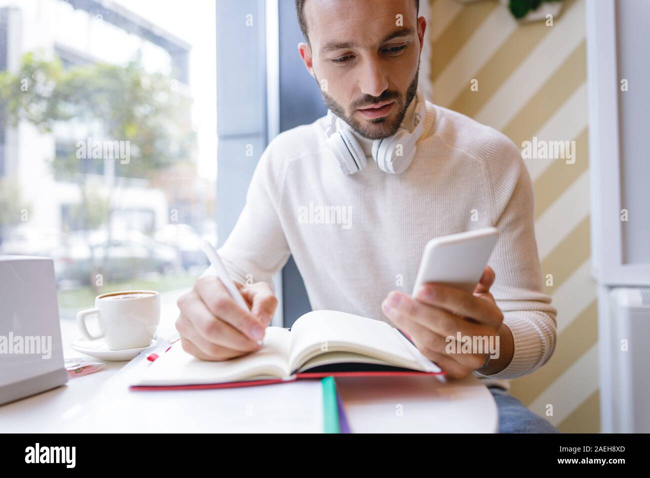 Close up of serious man that making notes Stock Photo - Alamy