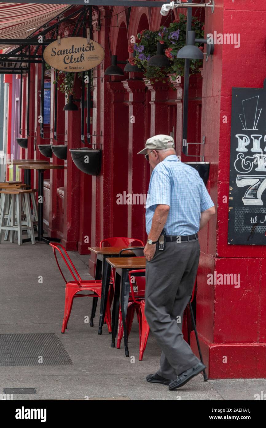 Senior man walking past a caf , City of Cork, County Cork, Ireland ...