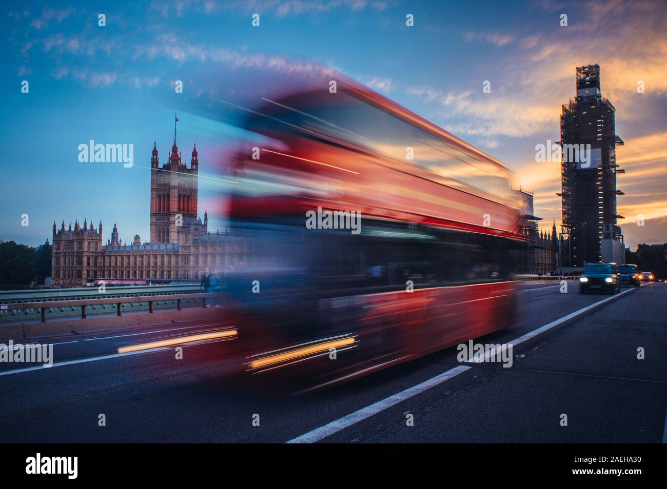 London. Classic red double decker bus crossing Westminster Bridge at ...