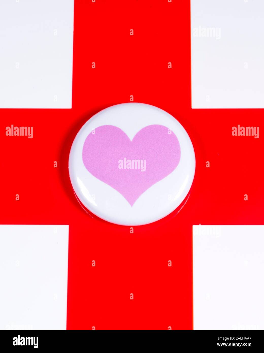 A pink heart symbol, pictured over the flag of England Stock Photo - Alamy