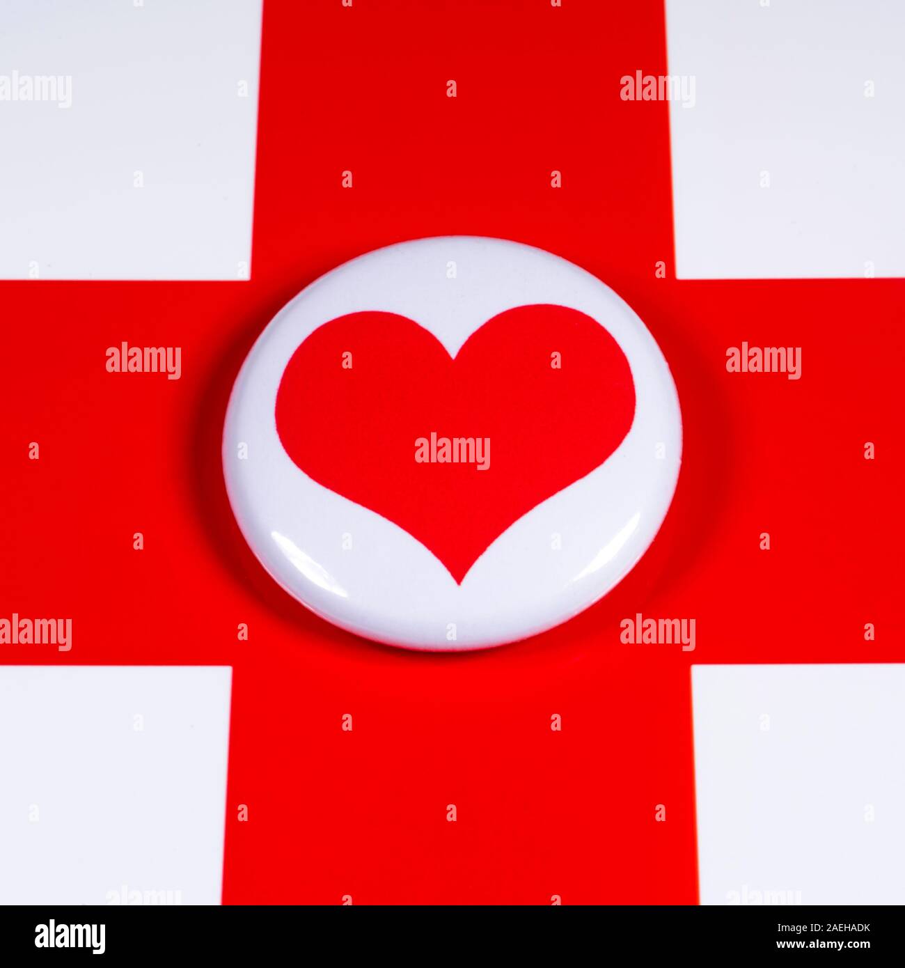 A red heart symbol, pictured over the flag of England Stock Photo - Alamy