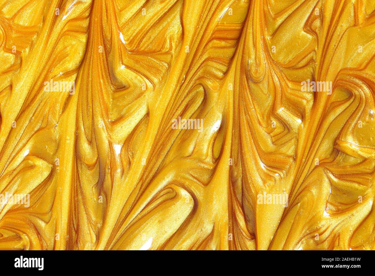 Close up liquid luxury gold metallic glitter paint swirls to make an ...