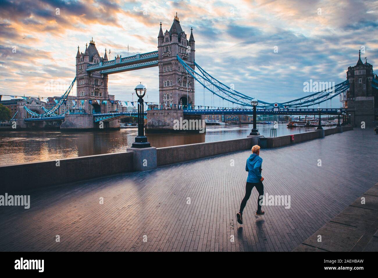 Running in London. Man train near by Tower Bridge, London, England ...