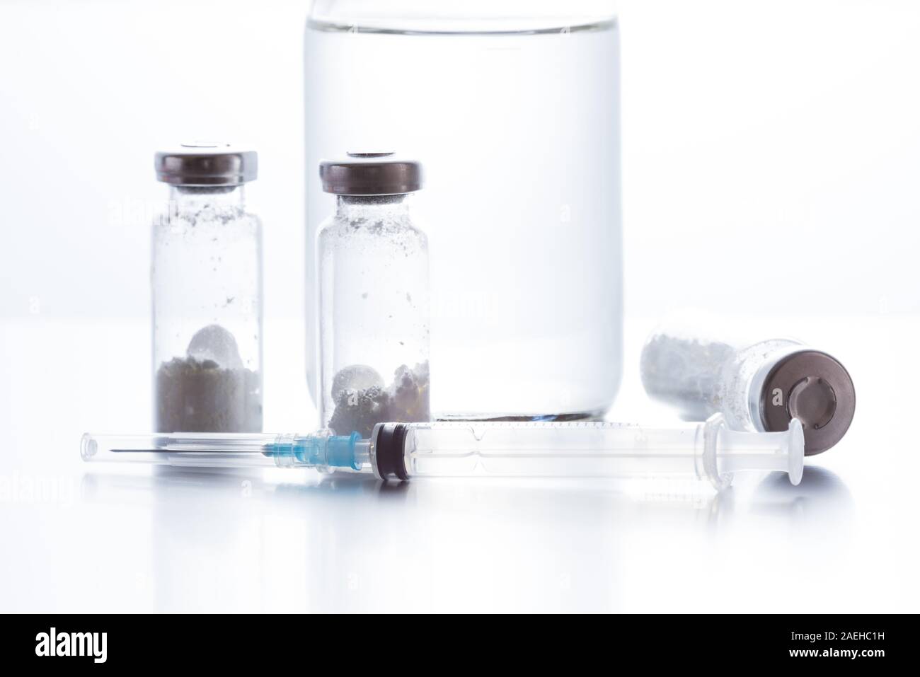 Antibiotic injection bottles with a plastic disposable syringe on a ...