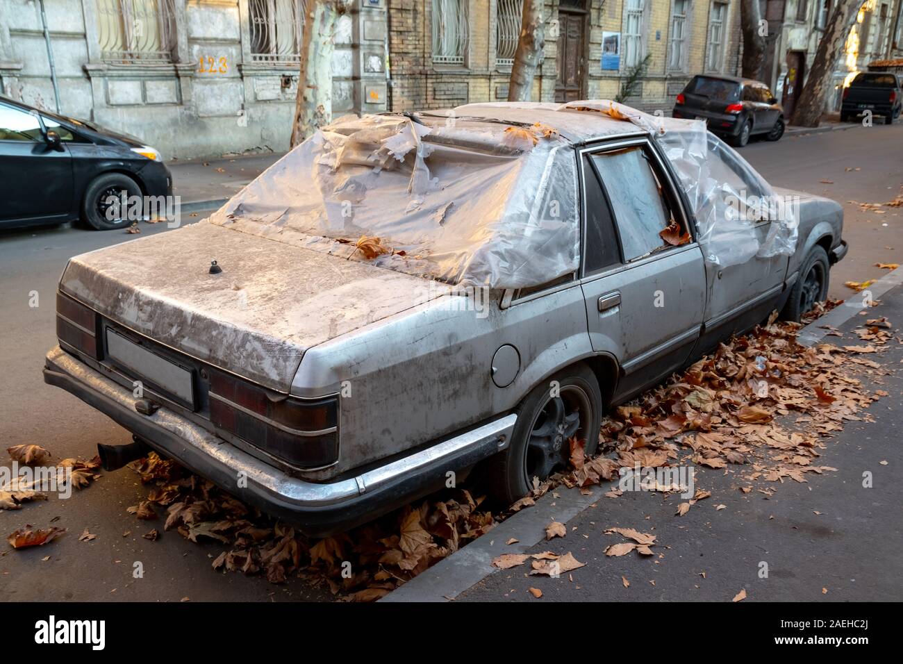 Rusty abandoned car on a city street. Tbilisi, Georgia Stock Photo - Alamy
