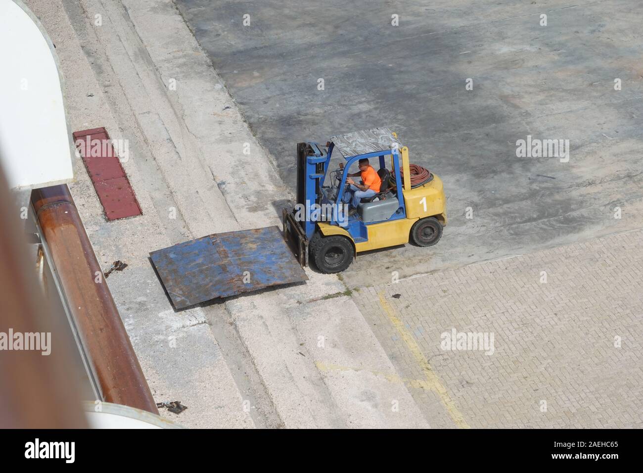 Aruba-11/4/19: Port Dock workers using a forklift to setup a ramp to ...