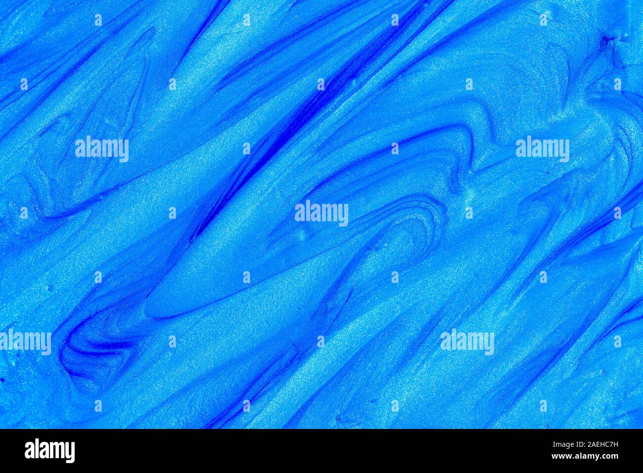 Close up liquid luxury blue metallic glitter paint swirls to make an ...