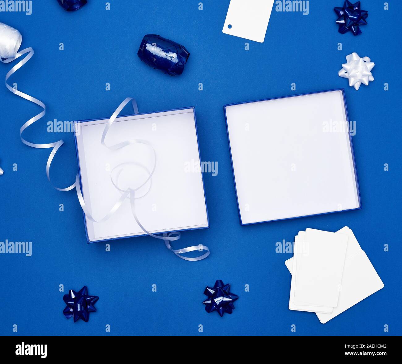 open cardboard gift square boxes, bows, ribbons for packaging on a dark ...