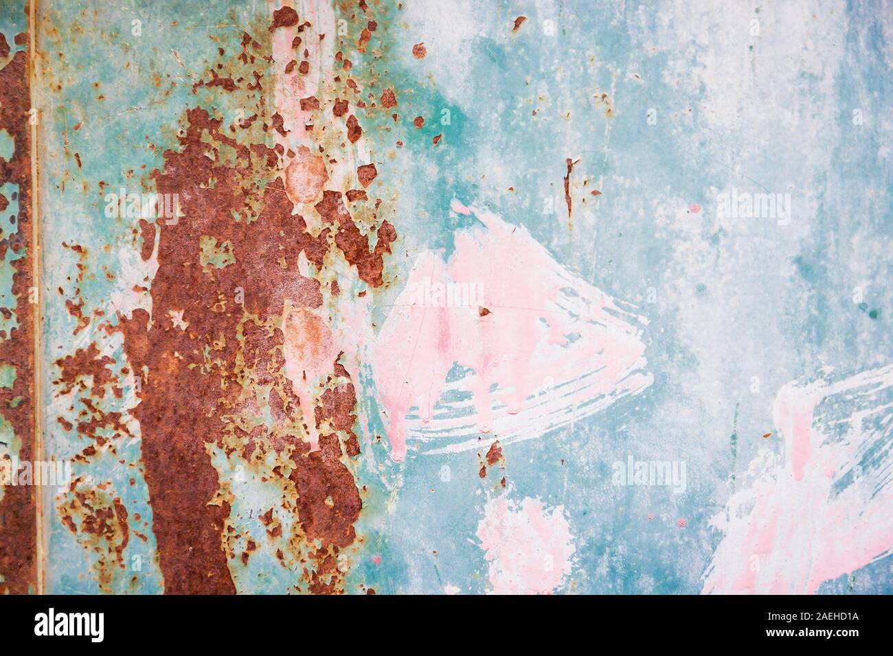 Rusty metal surface with pink, green, blue, turquoise paint flaking ...