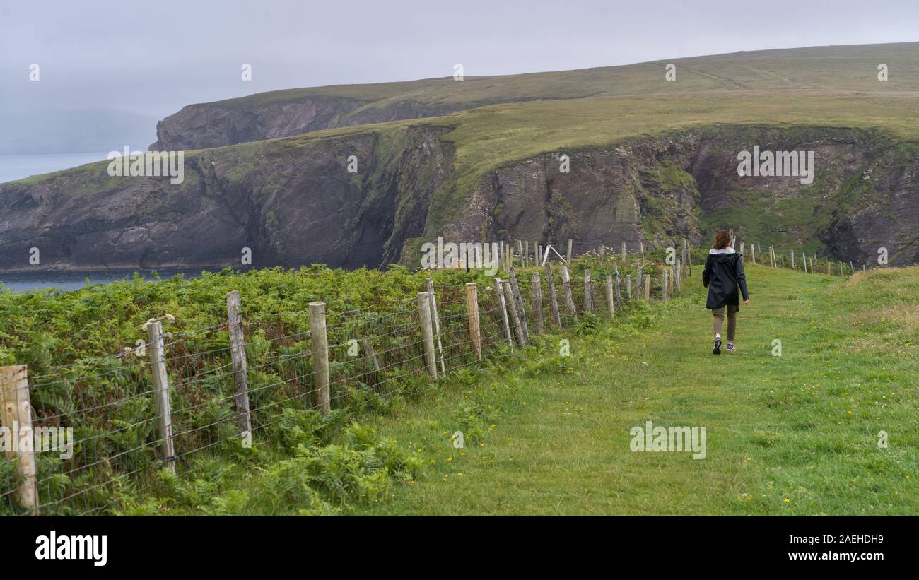 Woman walking on trail, Erris Head Loop Walk, Belmullet, County Mayo ...