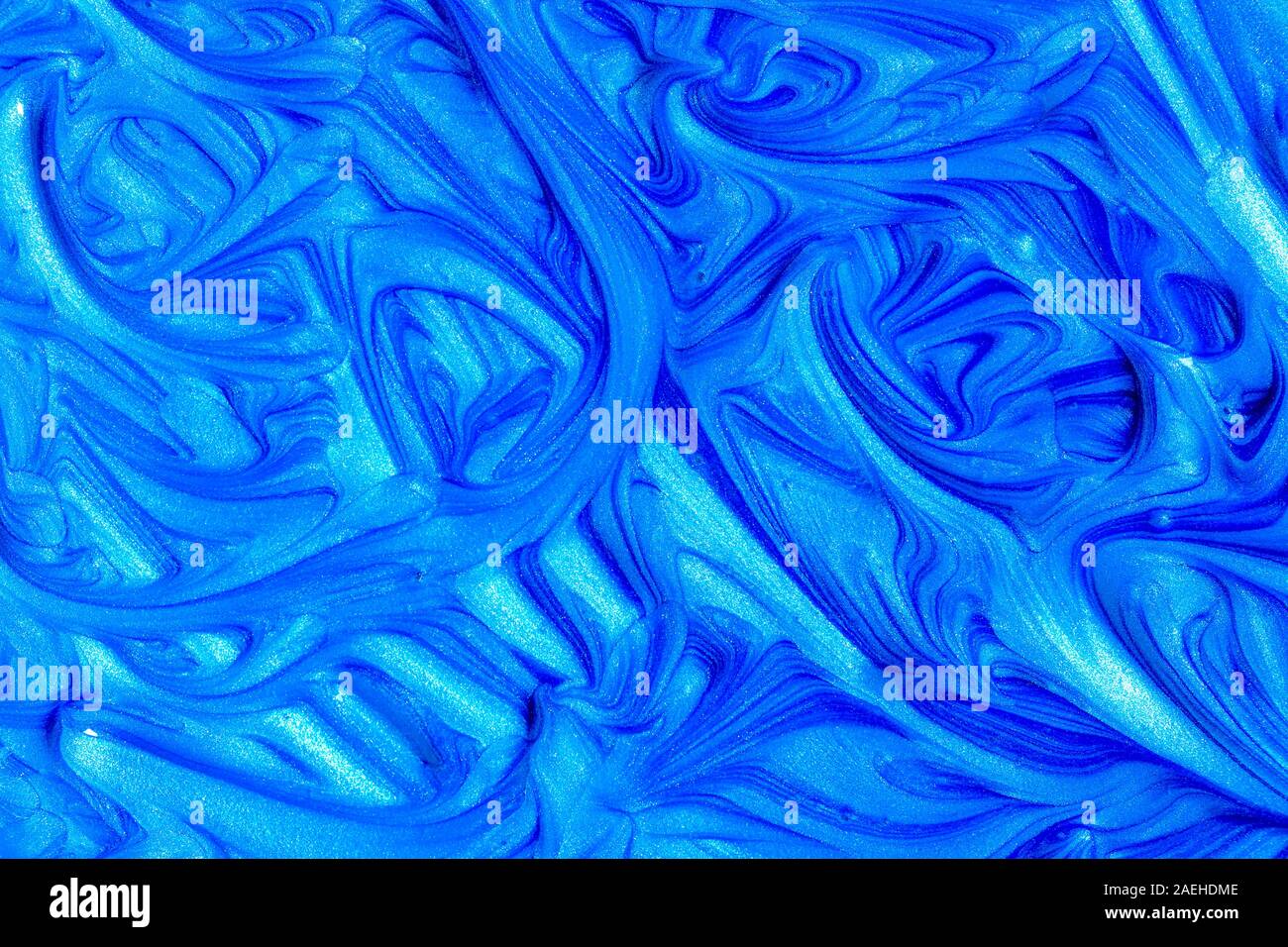 Close up liquid luxury blue metallic glitter paint swirls to make an ...