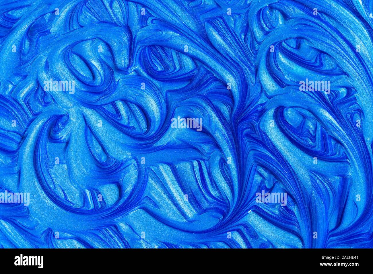 Close up liquid luxury blue metallic glitter paint swirls to make an ...