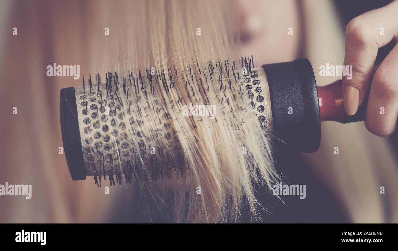 Round brushing combs long blond hair closeup Stock Photo - Alamy
