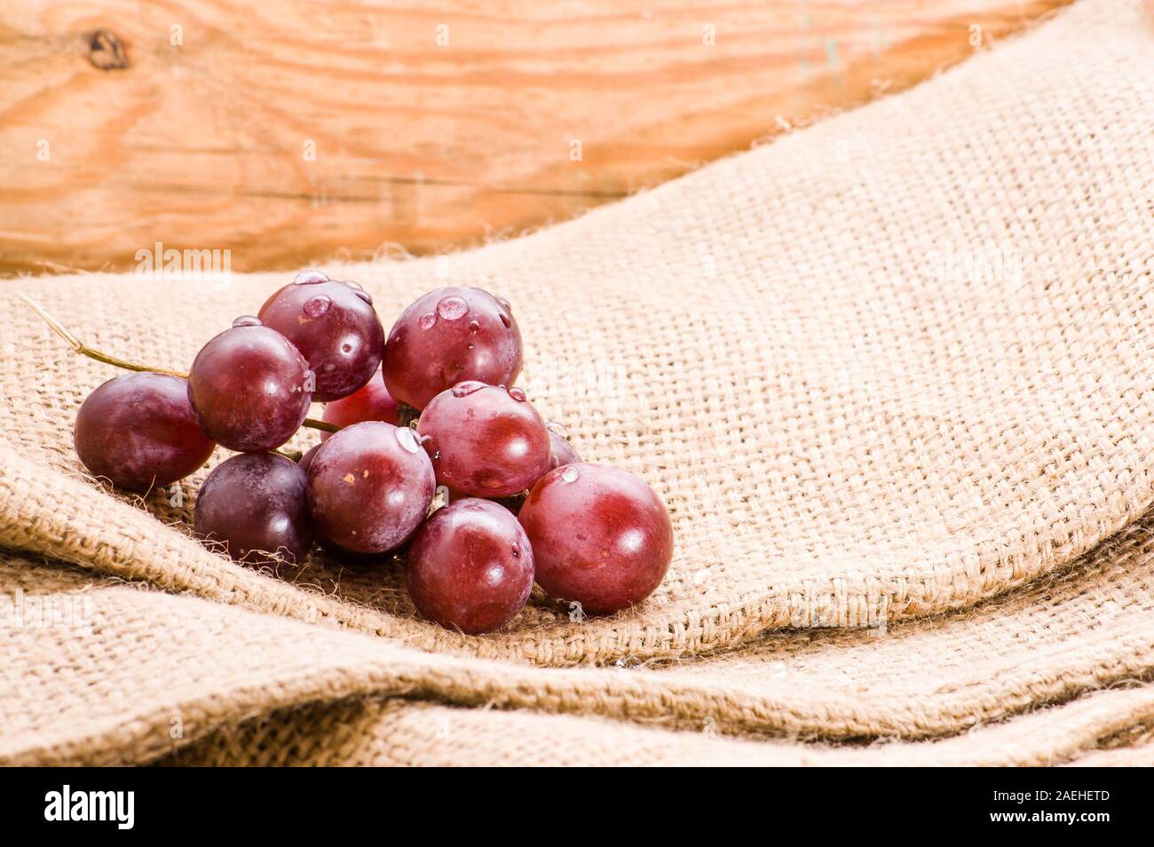 Red grapes, bunch on rustic background, healthy eating concept Stock ...