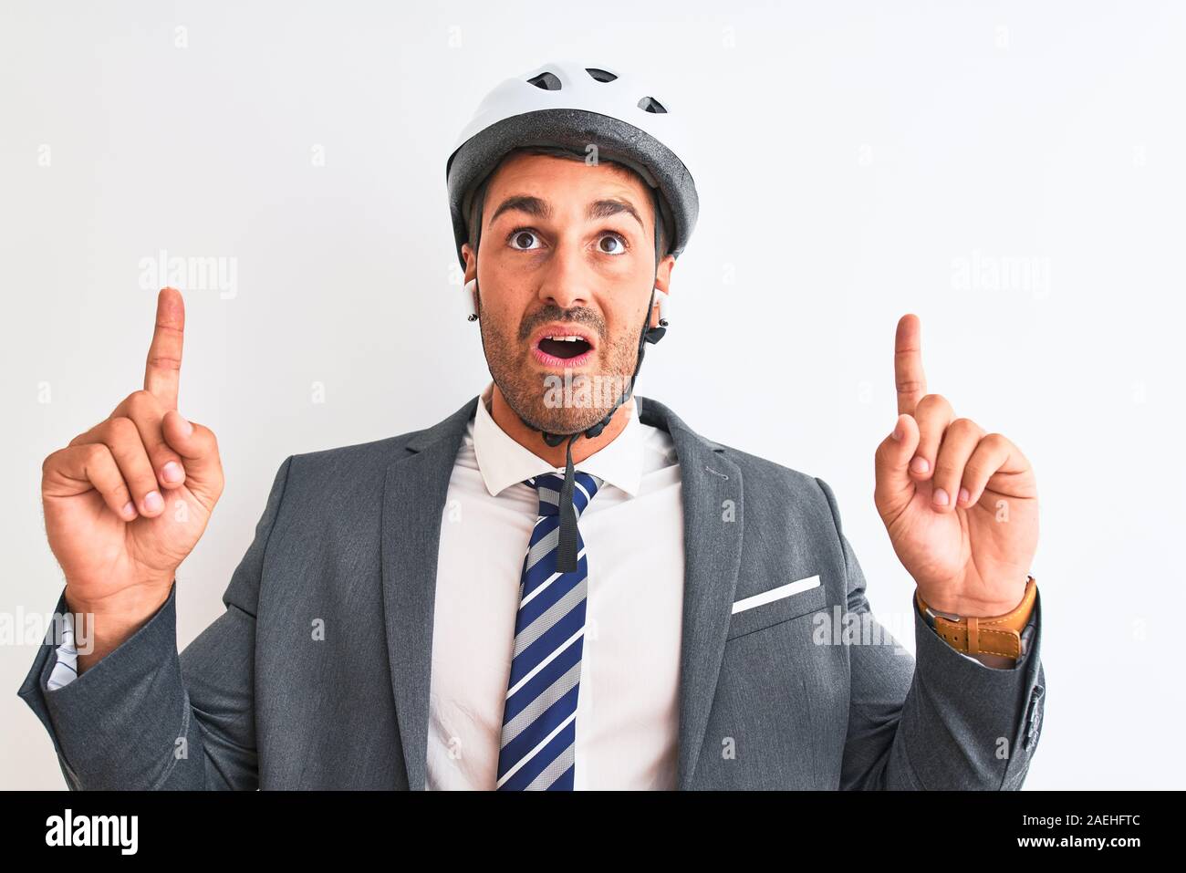 Young handsome business man bike helmet and wireless earphones over ...