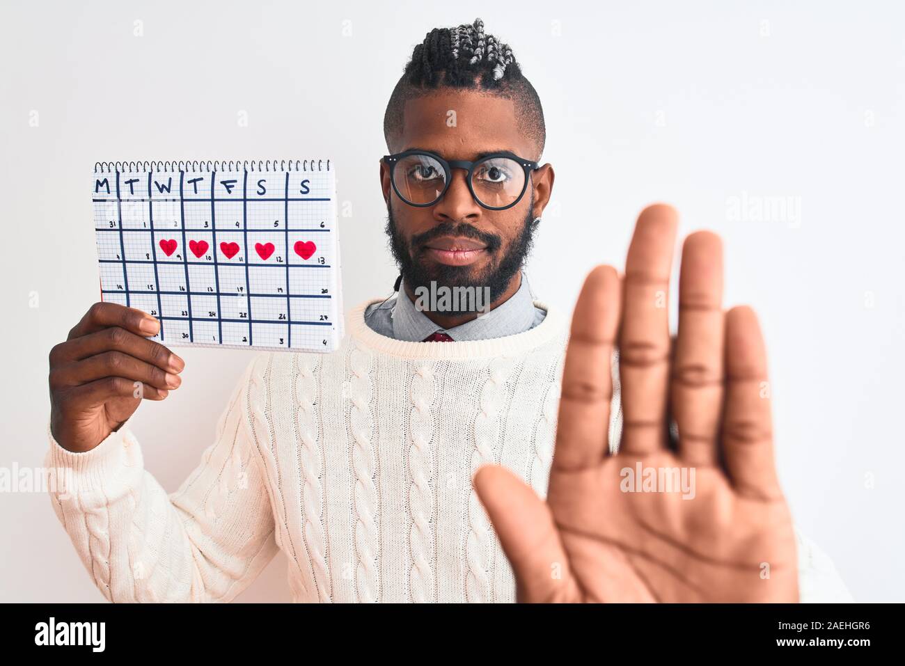 African american man with braids holding period calendar over isolated ...