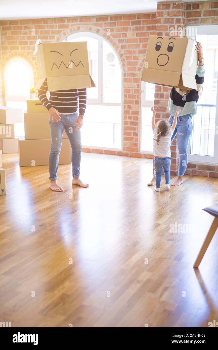 Beautiful famiily with kid playing with cardboard fanny boxes at new ...