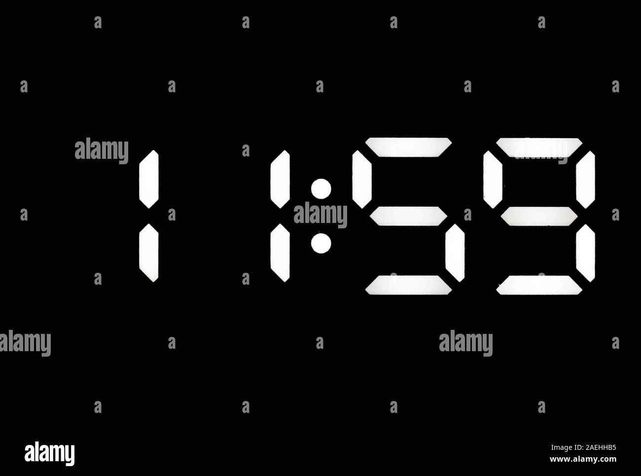 Real white led digital clock on a black background showing time 11:59 ...