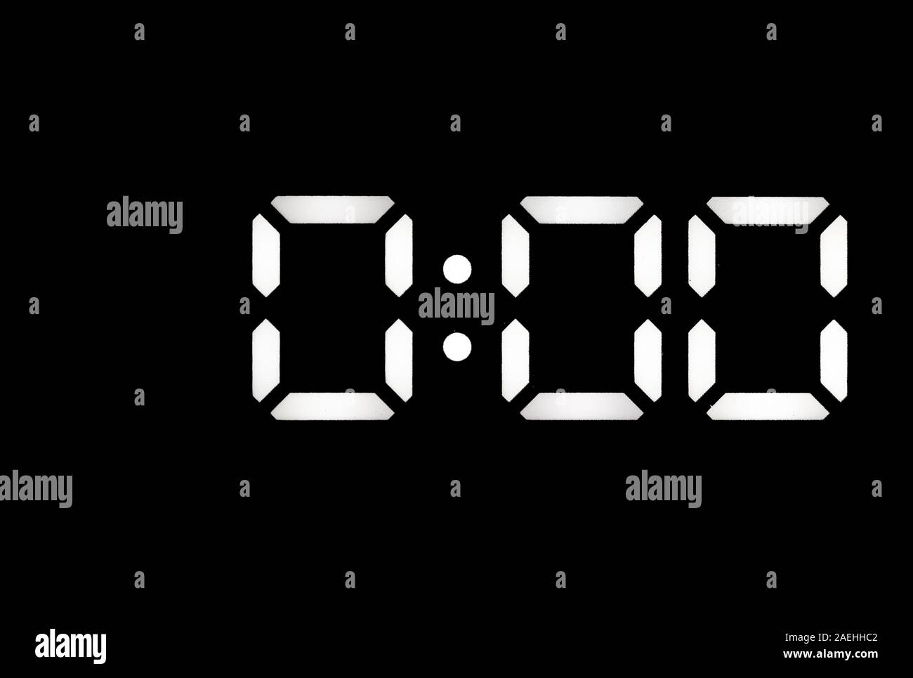 Real white led digital clock on a black background showing time 0:00 ...
